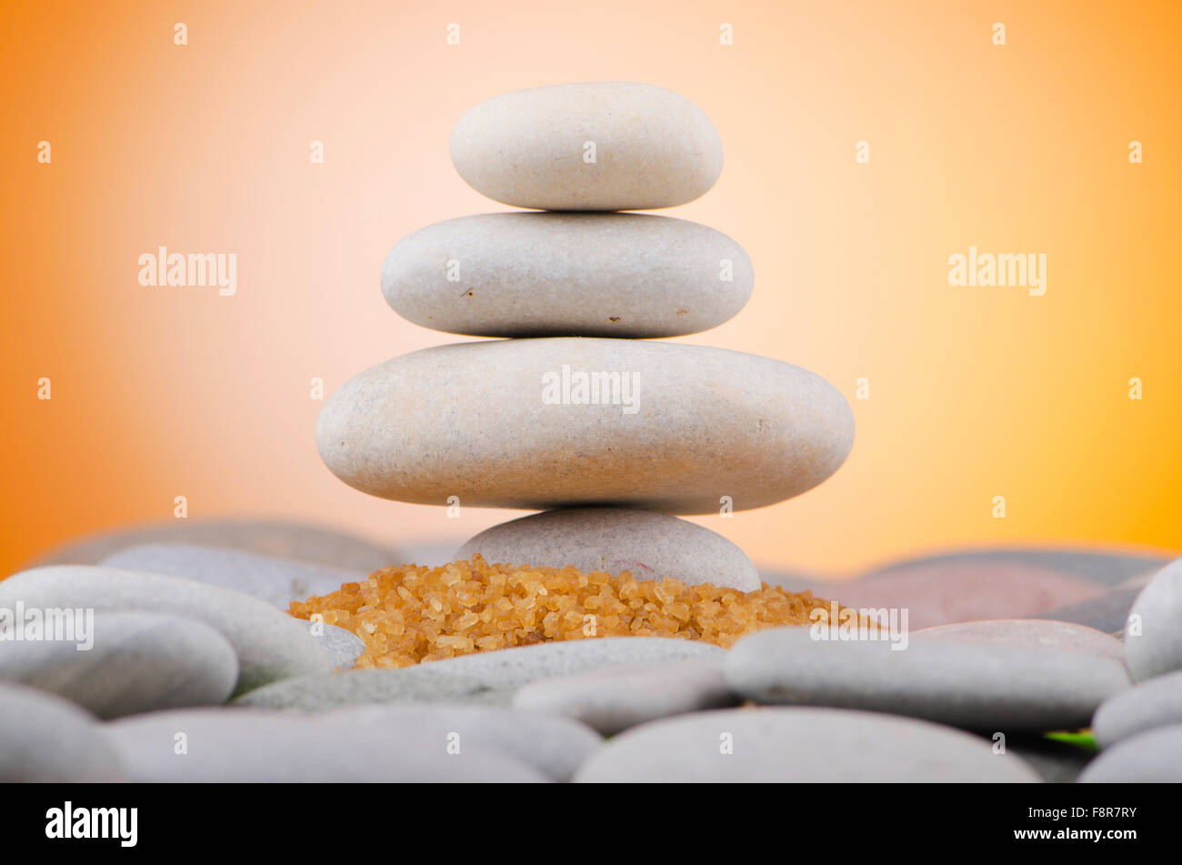 Balanced pebbles with colour background Stock Photo - Alamy