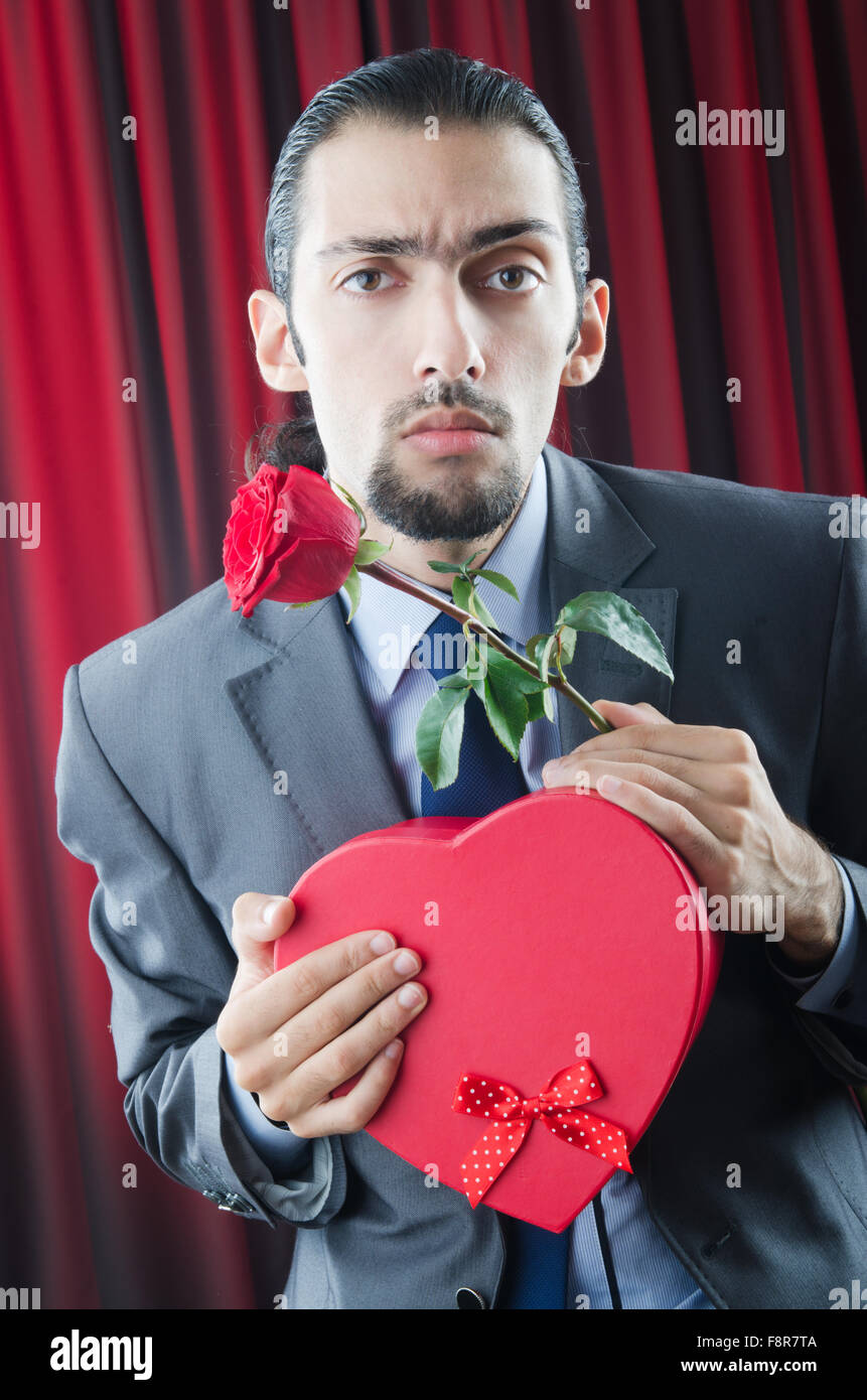 Young man with red rose Stock Photo - Alamy