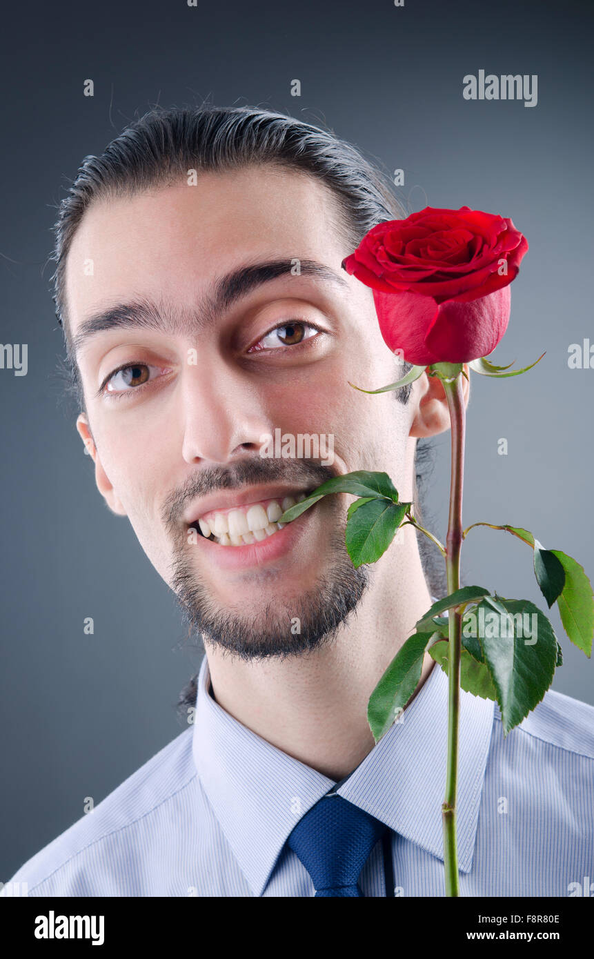 Young man with red rose Stock Photo - Alamy