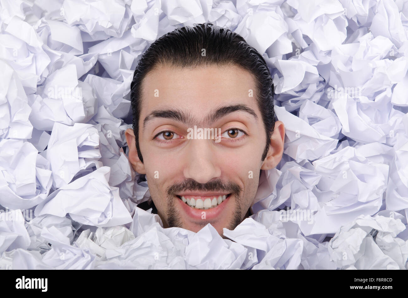 Man with lots of crumpled paper Stock Photo - Alamy
