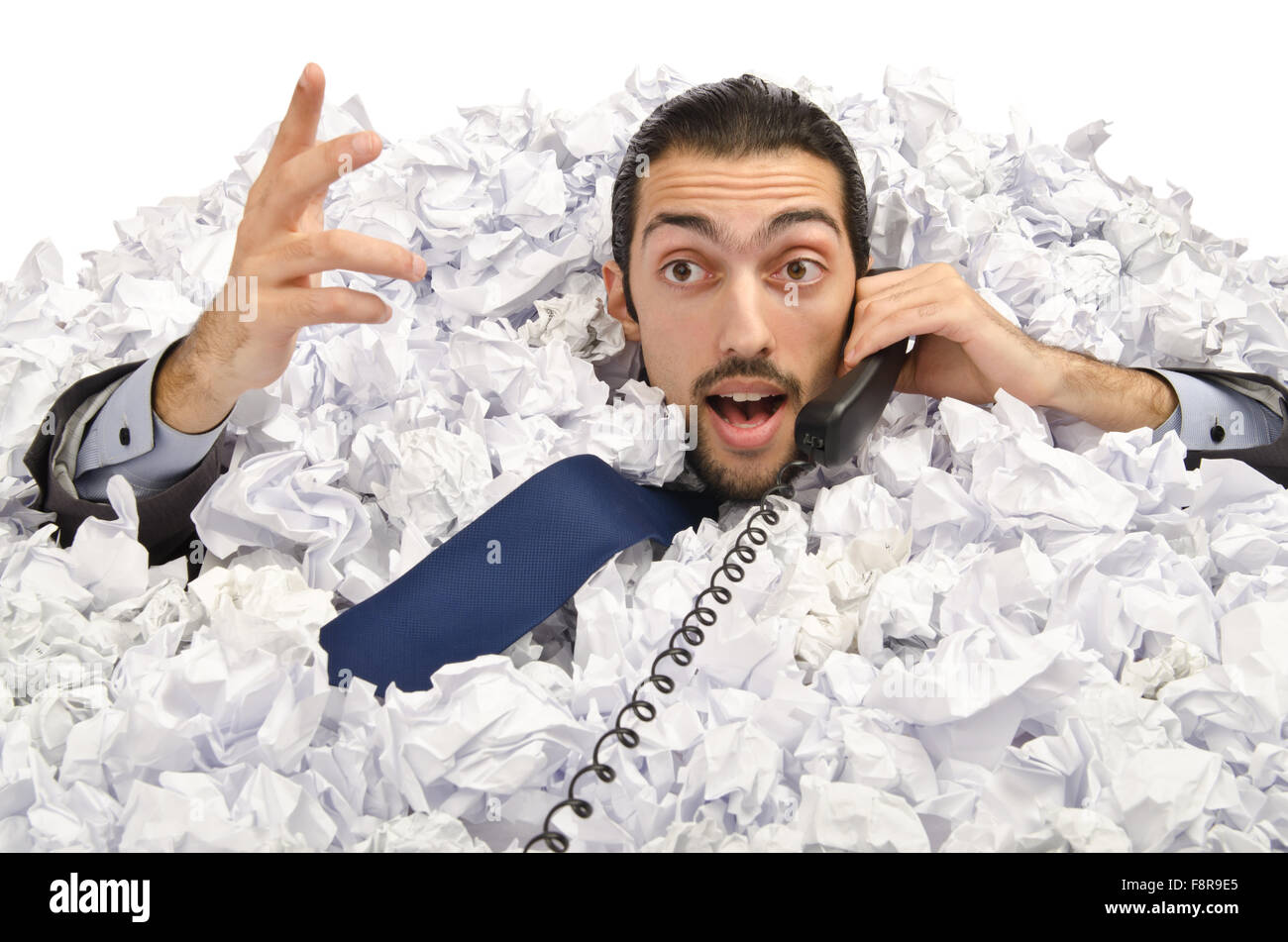 Man with lots of crumpled paper Stock Photo - Alamy