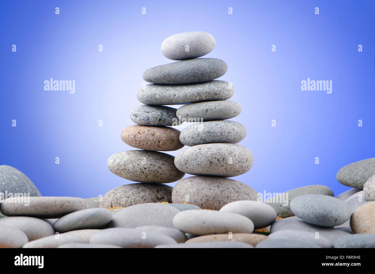Balanced pebbles with colour background Stock Photo - Alamy