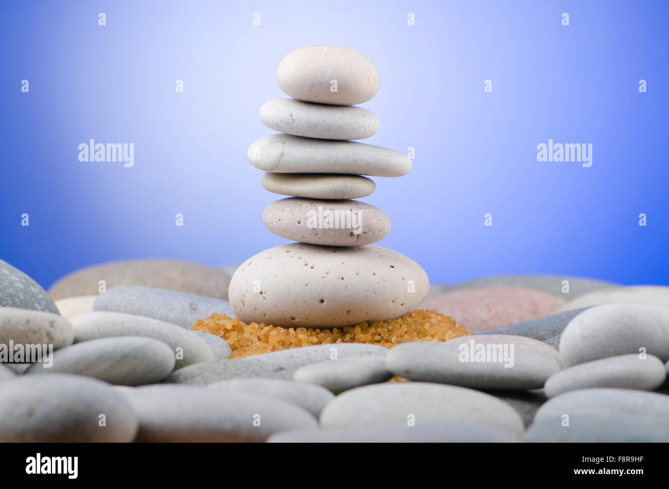 Balanced pebbles with colour background Stock Photo - Alamy
