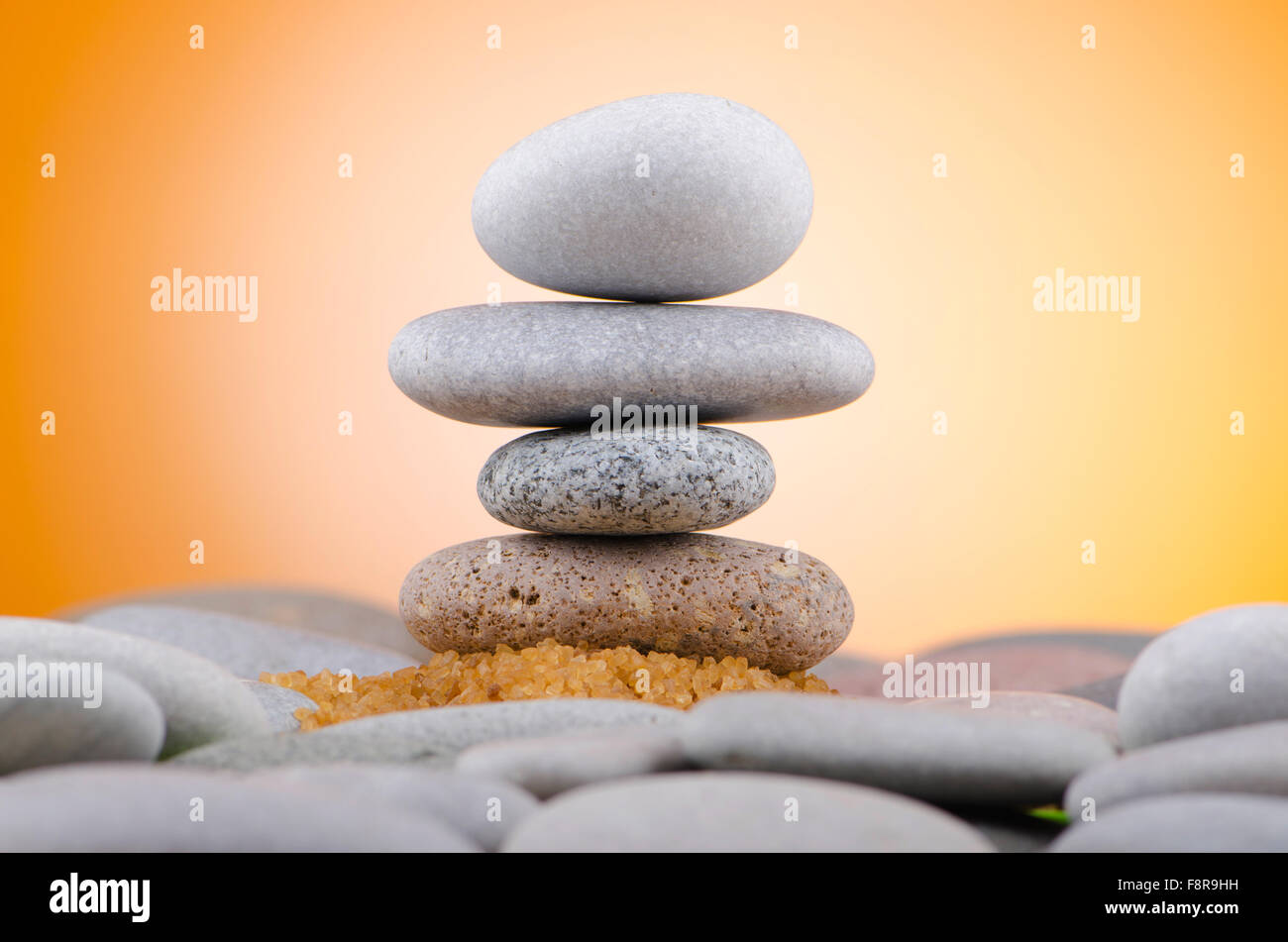 Balanced pebbles with colour background Stock Photo - Alamy