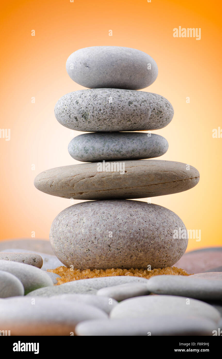 Balanced pebbles with colour background Stock Photo - Alamy