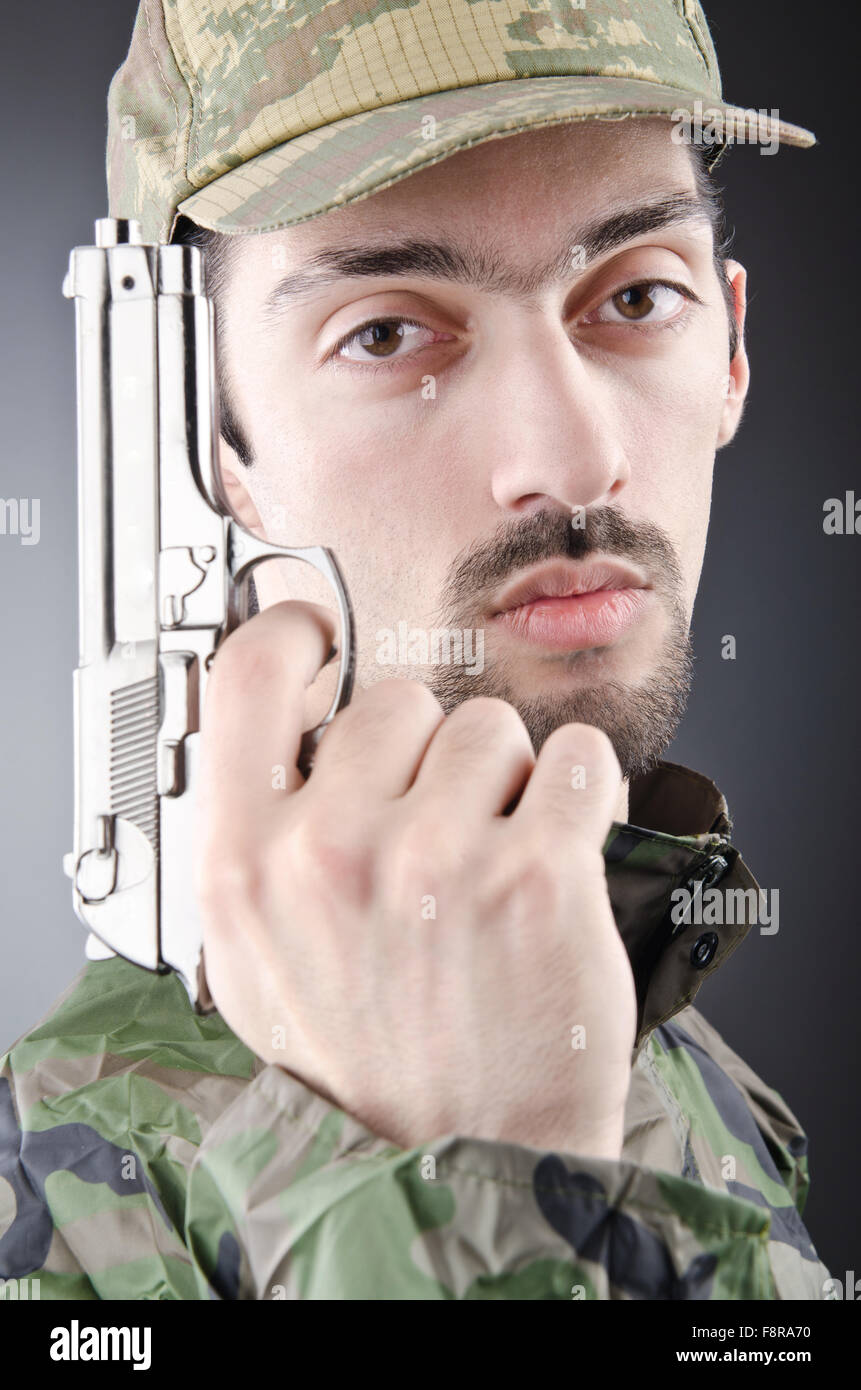 Soldier with gun in studio shooting Stock Photo - Alamy