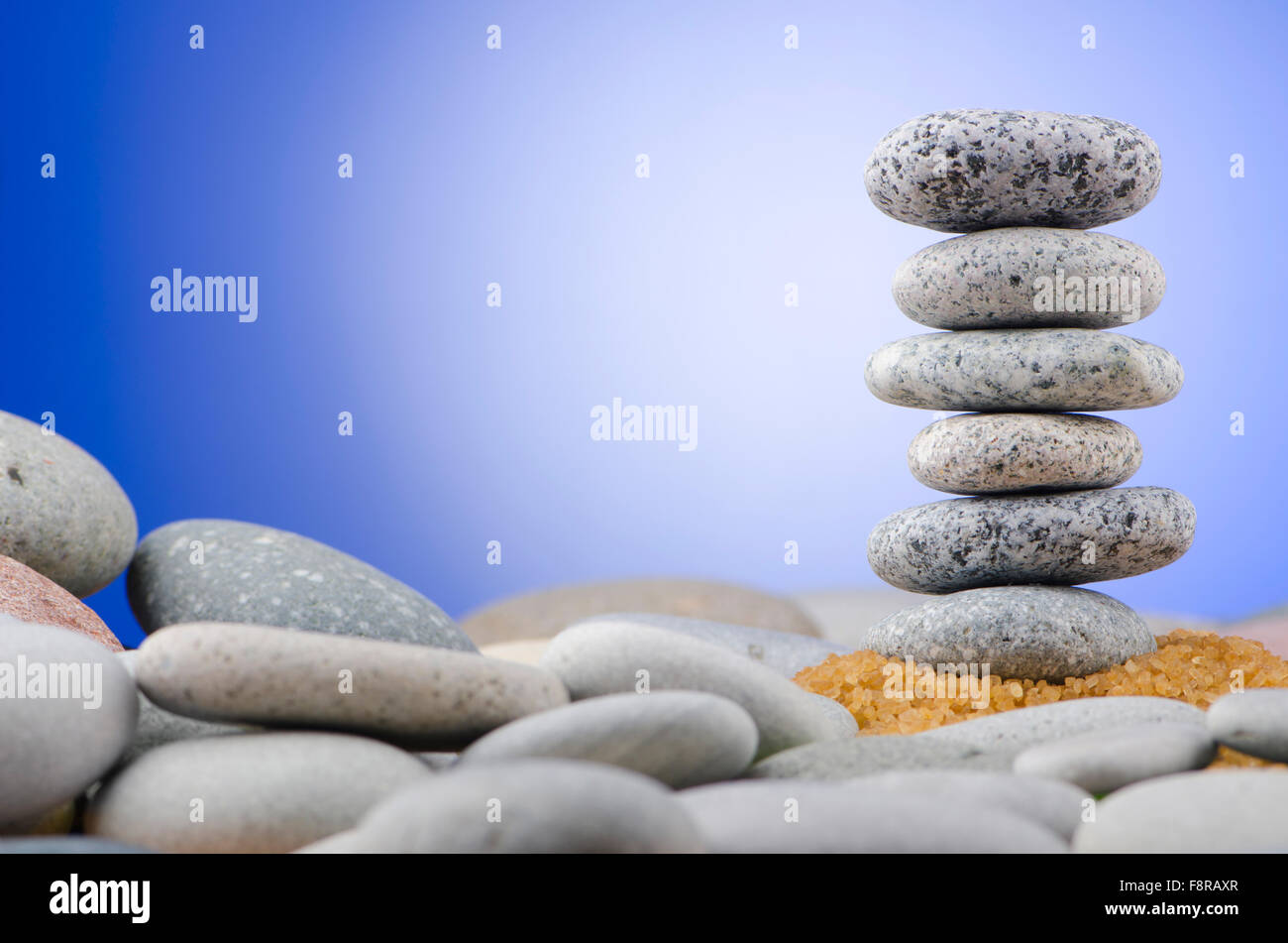 Balanced pebbles with colour background Stock Photo - Alamy