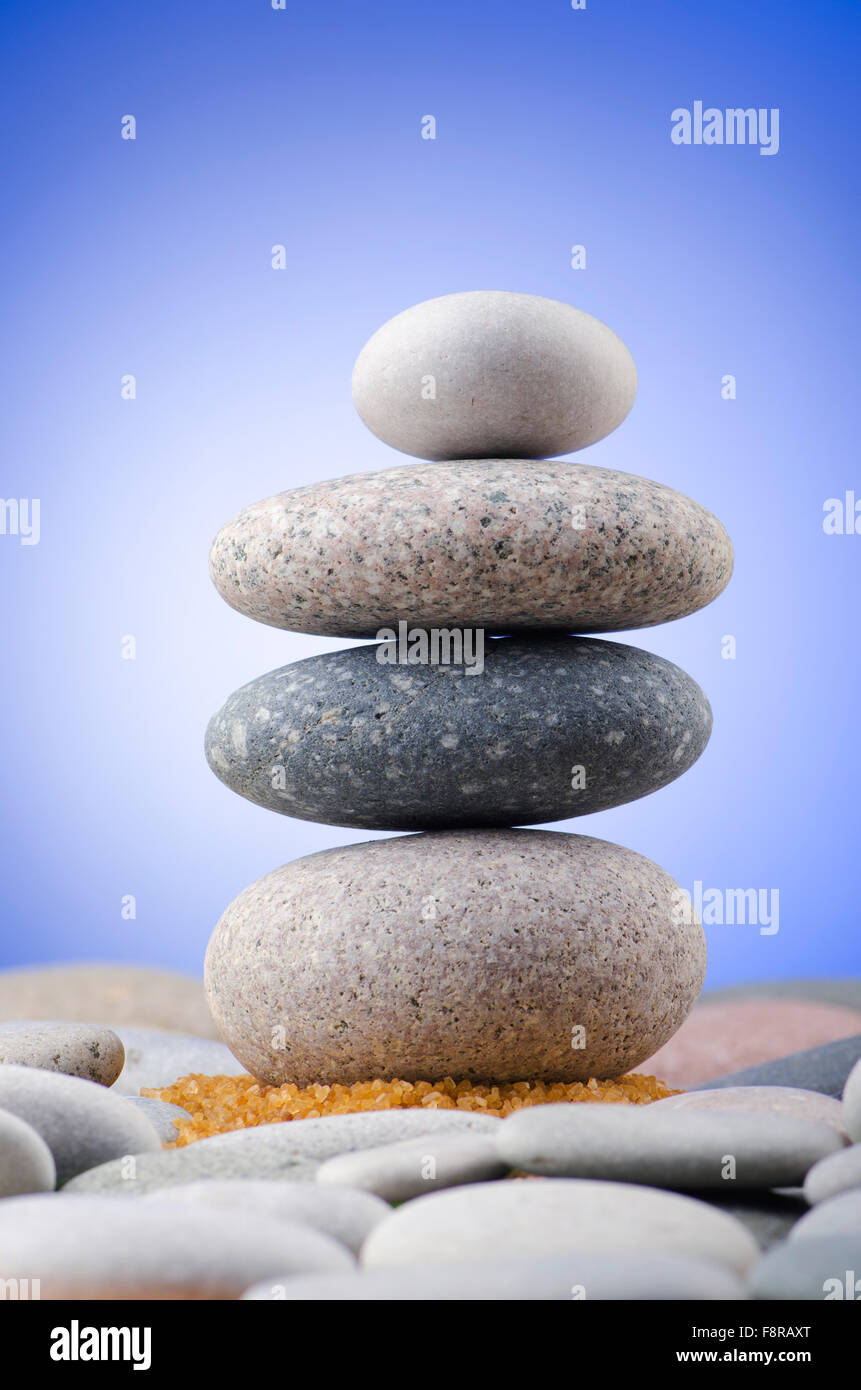 Balanced pebbles with colour background Stock Photo - Alamy