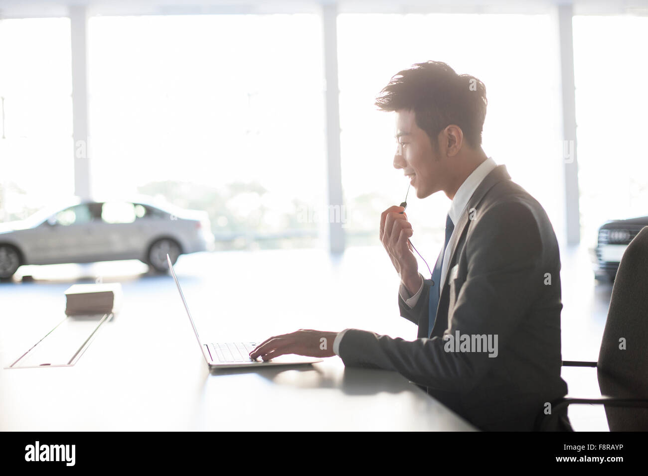 Car salesman working with laptop Stock Photo - Alamy
