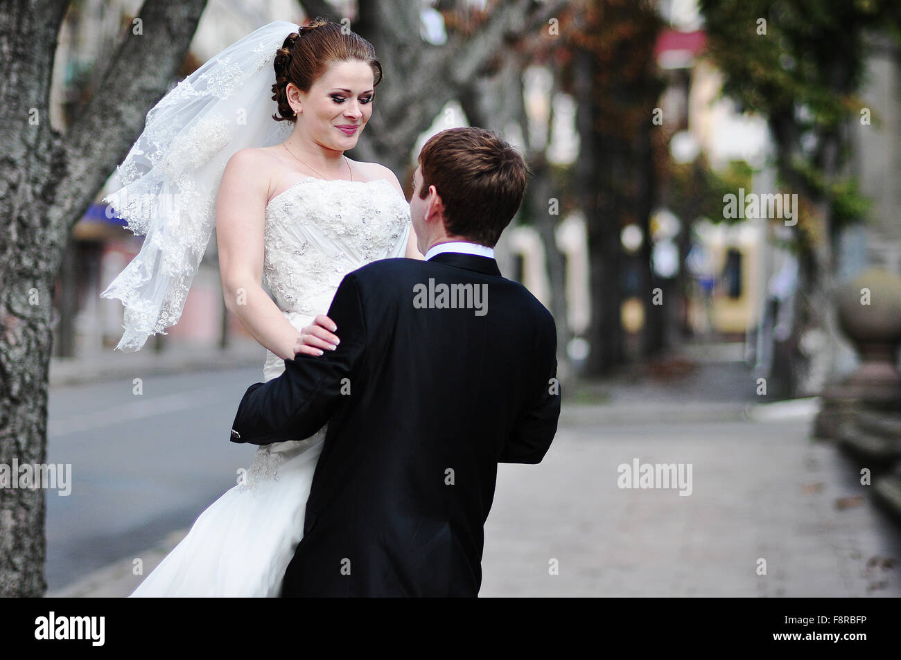 Groom hold bride on hands Stock Photo - Alamy