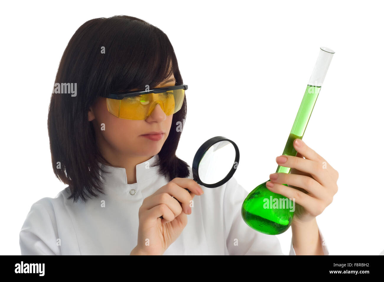 Female scientist looking at tube through magnifying lens Stock Photo ...