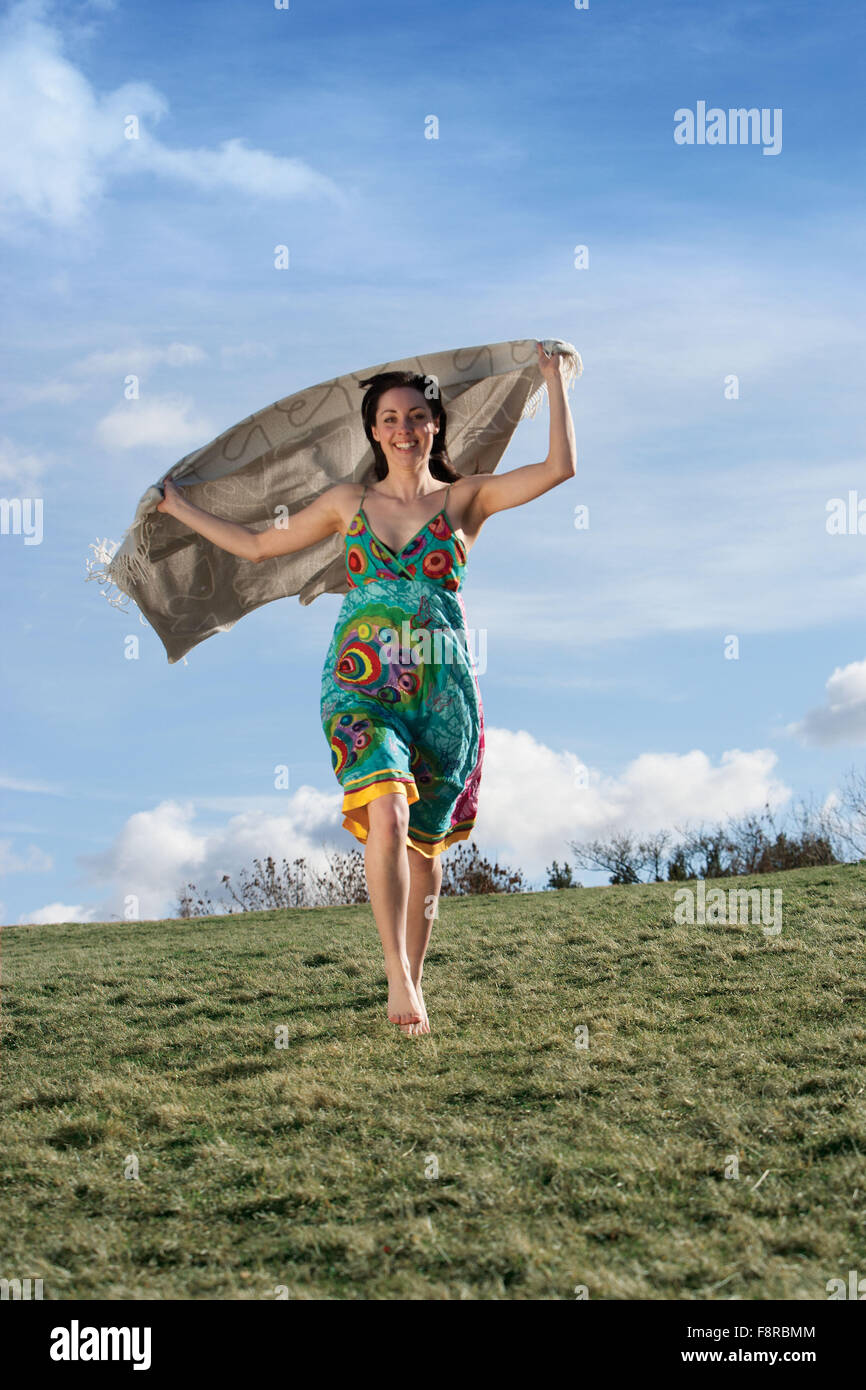young woman running with a blanket behind her Stock Photo - Alamy