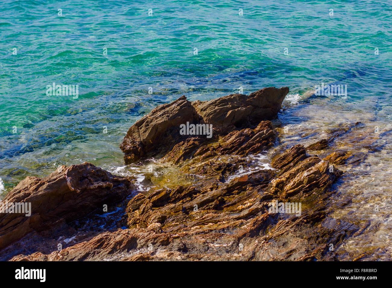 Coast with rocks on the beautiful turquoise Aegean Sea. Chalkidiki ...
