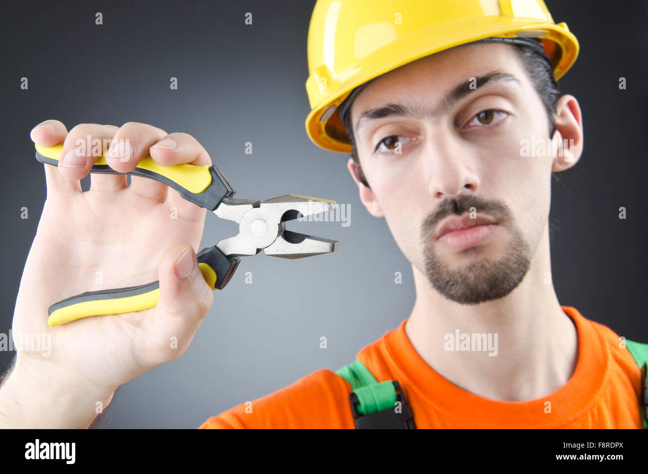 Man with tongs in studio Stock Photo - Alamy