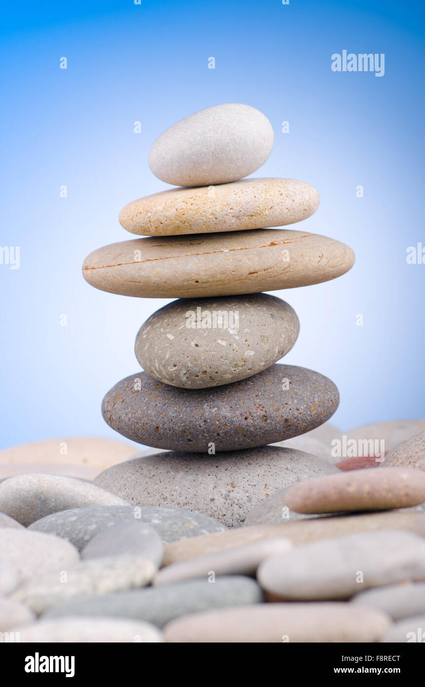 Pebbles stack against gradient background Stock Photo - Alamy
