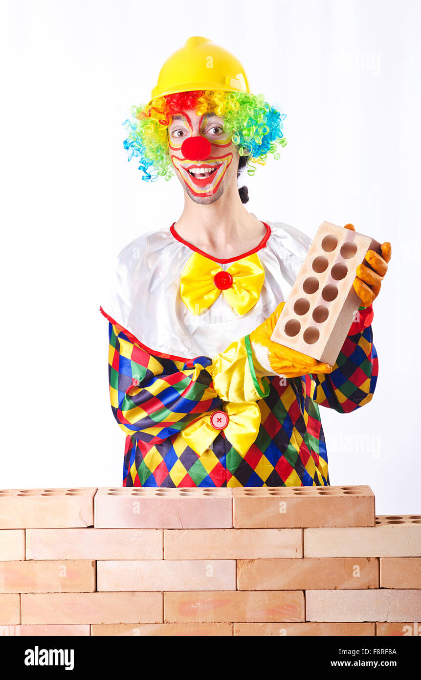 Bad construction concept with clown laying bricks Stock Photo - Alamy
