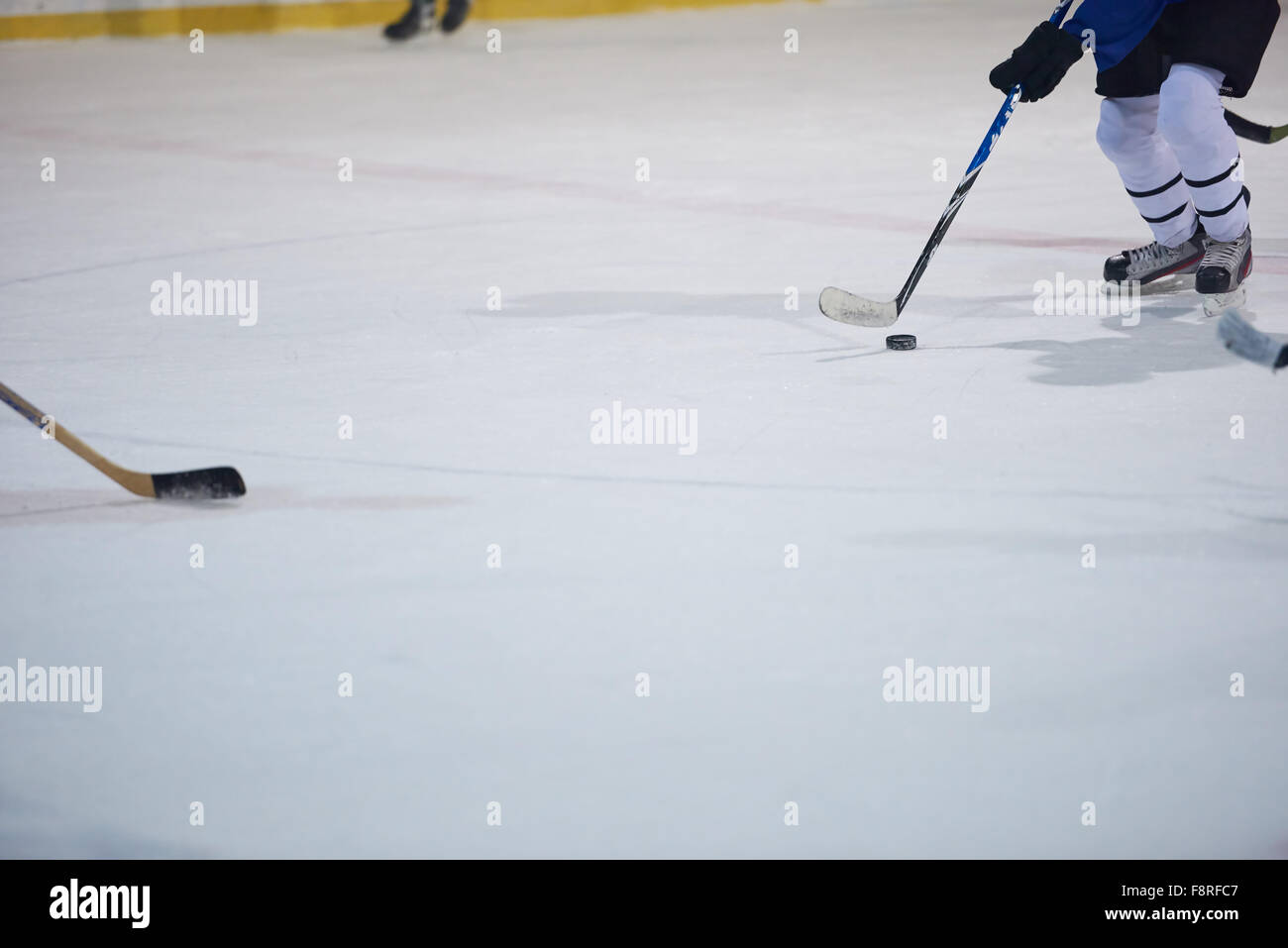 ice hockey player in action kicking with stick Stock Photo - Alamy