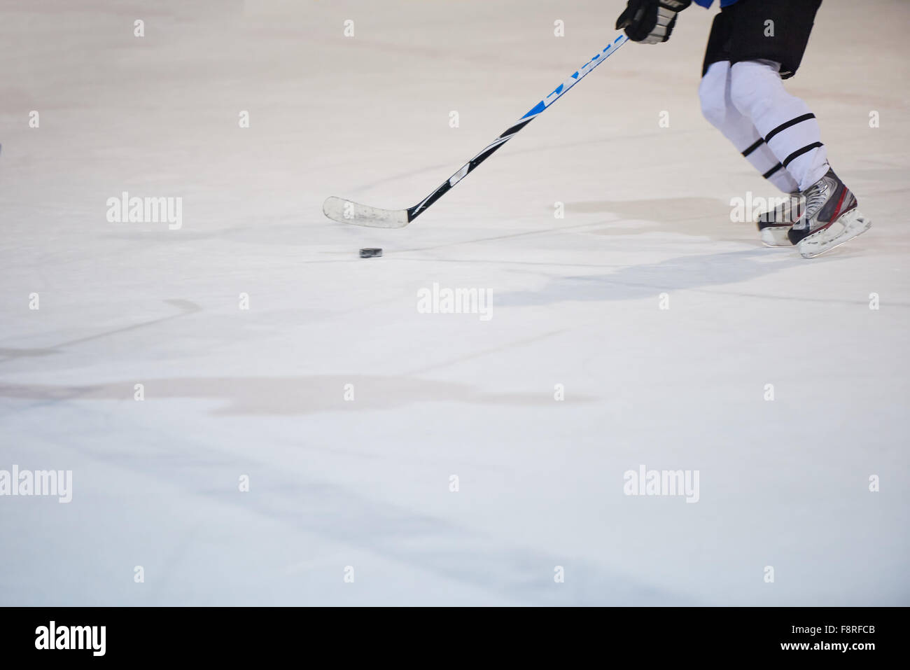 ice hockey player in action kicking with stick Stock Photo - Alamy