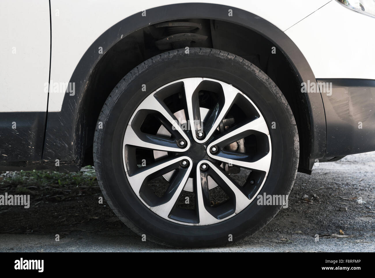 Closeup photo of modern car wheel on asphalt road Stock Photo - Alamy