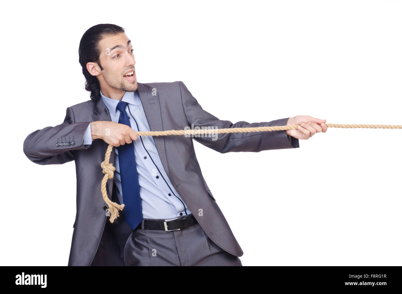 Businessman pulling rope on white Stock Photo - Alamy