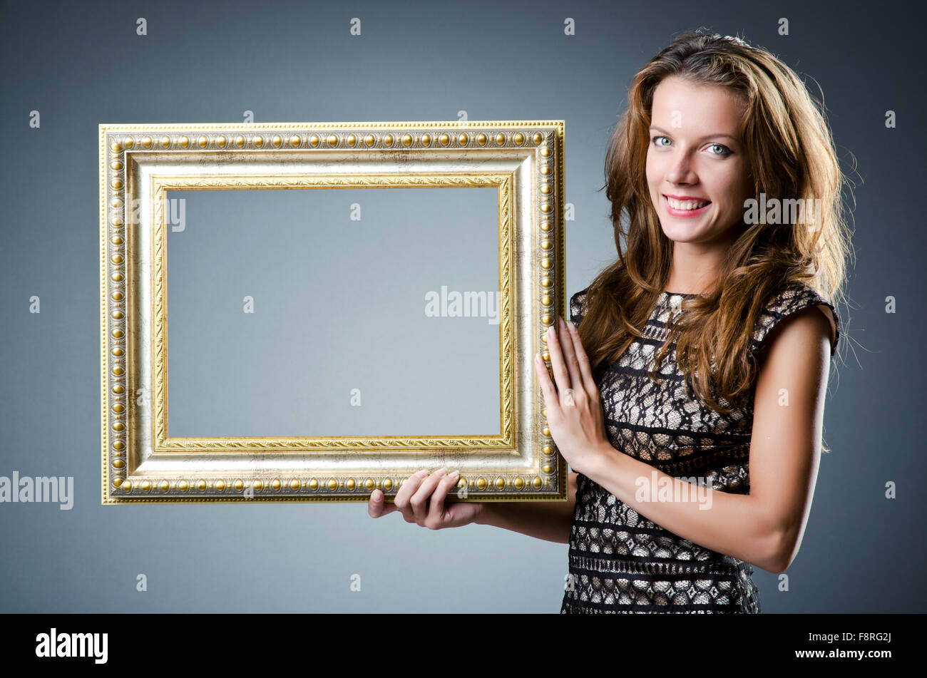 Young woman with picture frame on white Stock Photo - Alamy