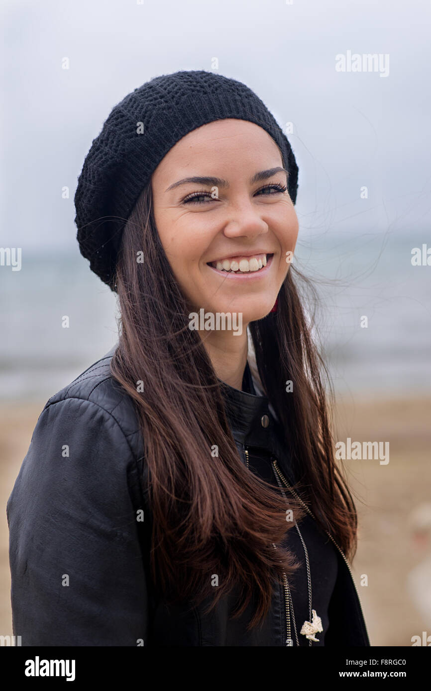 Smiling woman on the beach Stock Photo - Alamy