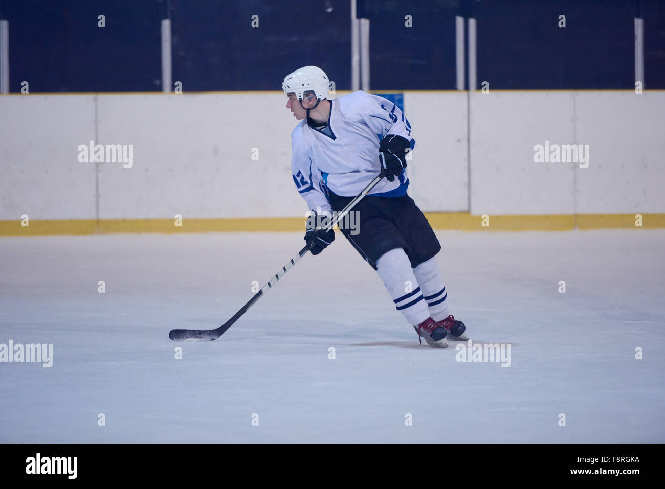 ice hockey player in action kicking with stick Stock Photo - Alamy