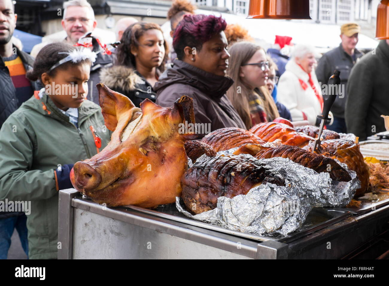 A pigs head on a stall as customers queue for hot pork rolls at ...