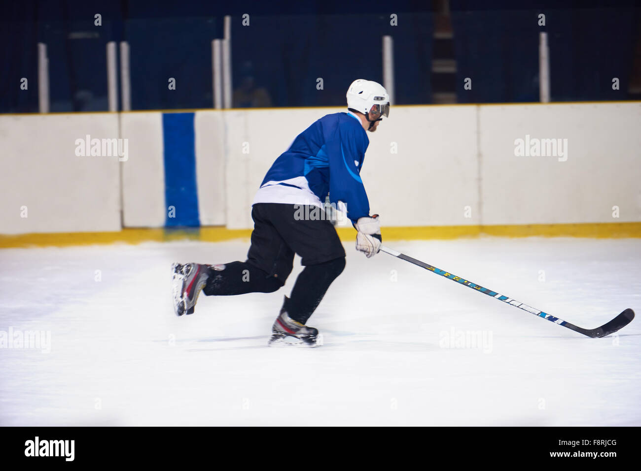 ice hockey player in action kicking with stick Stock Photo - Alamy