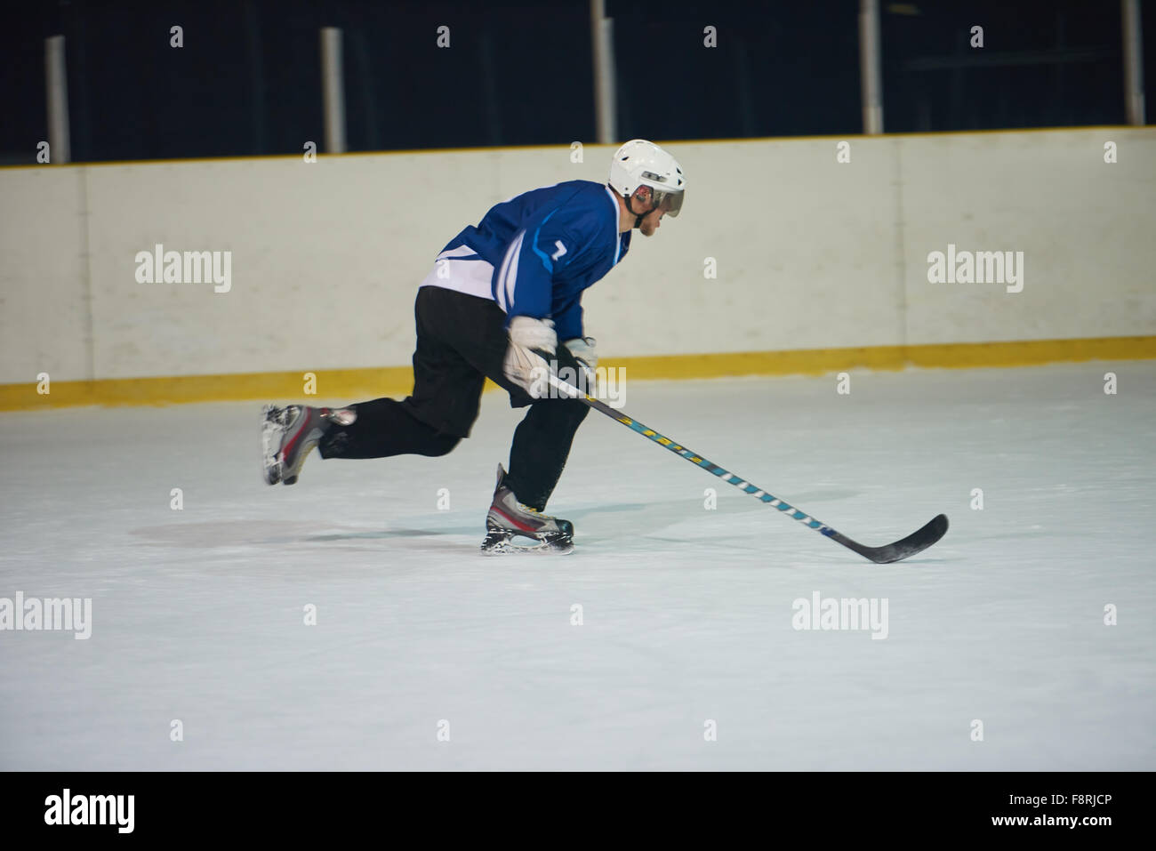 ice hockey player in action kicking with stick Stock Photo - Alamy