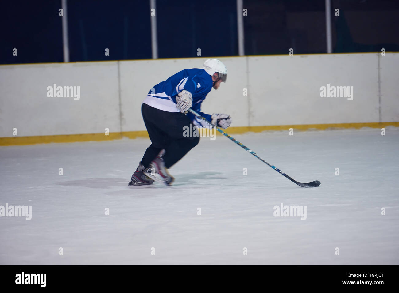 ice hockey player in action kicking with stick Stock Photo - Alamy