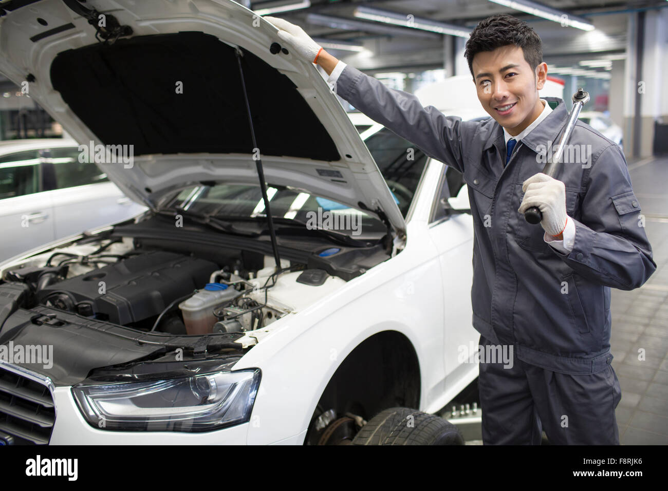 Standing holding work tool auto repair shop transportation industry hi ...