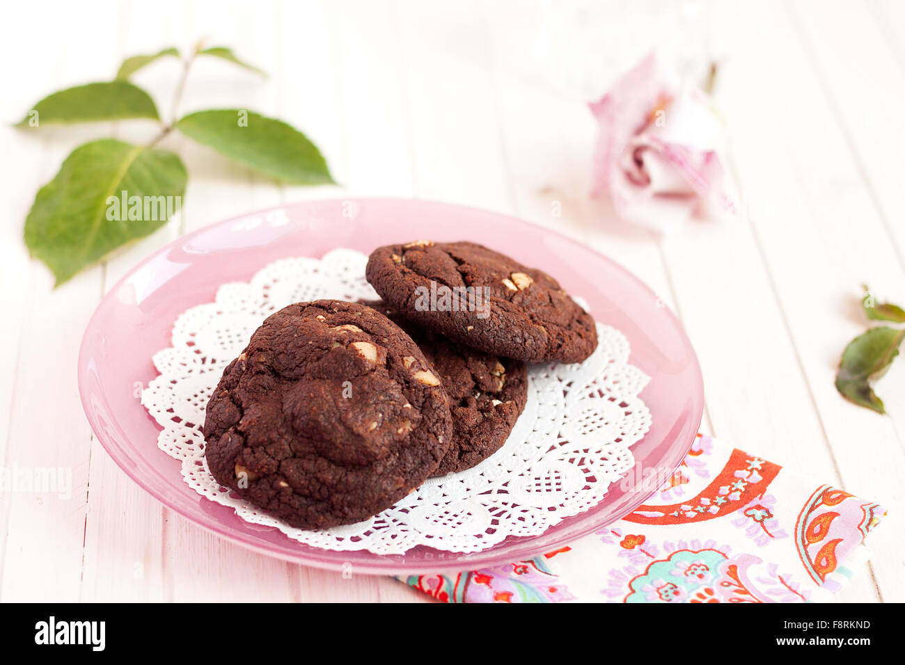 Three Chocolate chip cookies on a plate Stock Photo - Alamy
