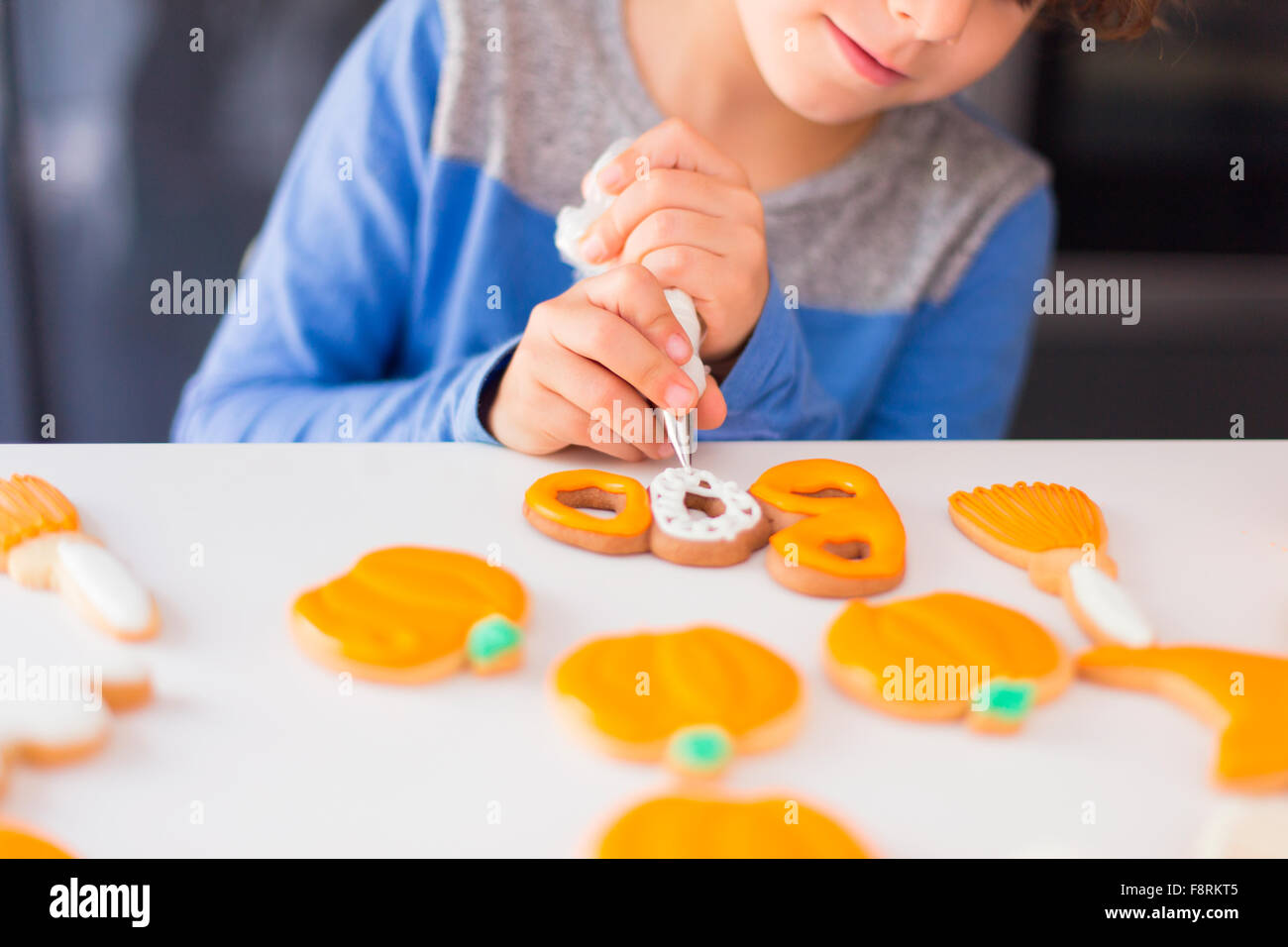 Boy icing cakes Stock Photo - Alamy