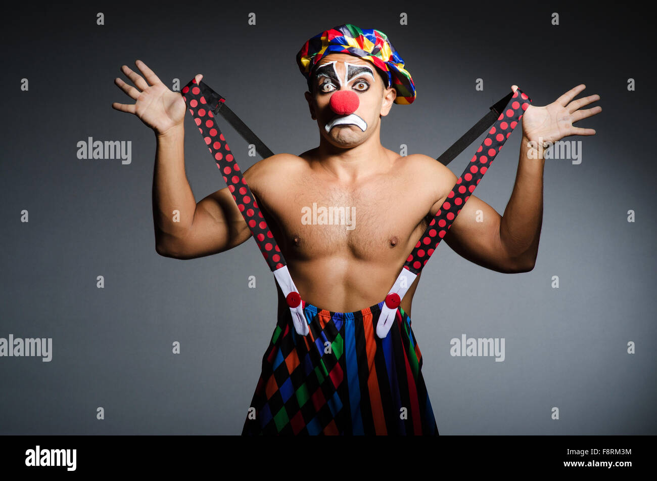 Sad clown against dark background Stock Photo - Alamy