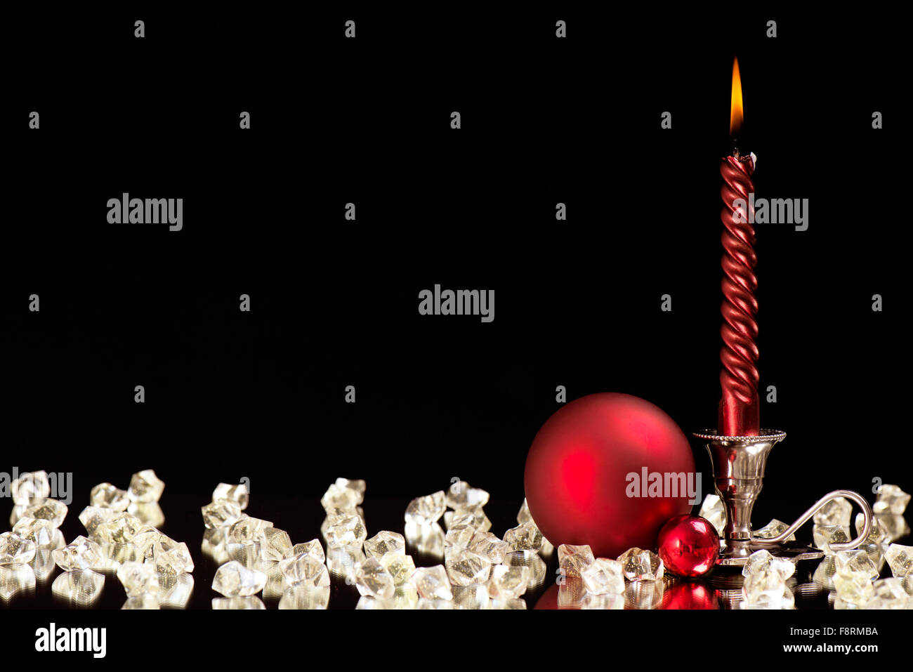 one red spiral candles in silver candlesticks, two red glass decorative ...