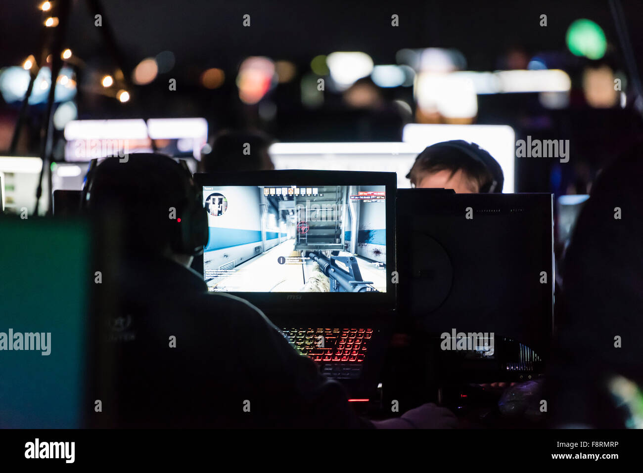 Computer game players are playing the first person shooter ...