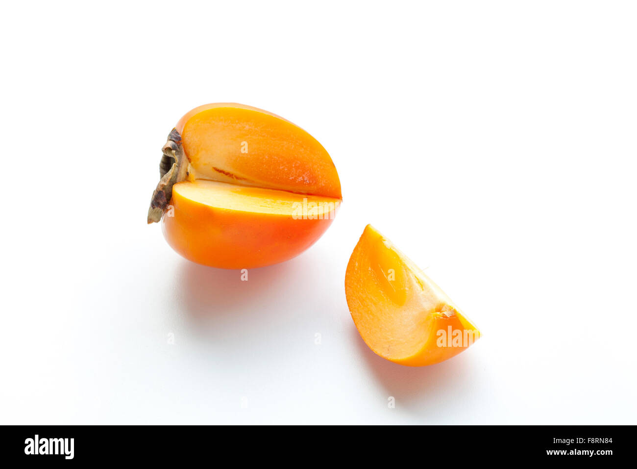 Ripe persimmon with cut isolated on white background. Clipping Path ...