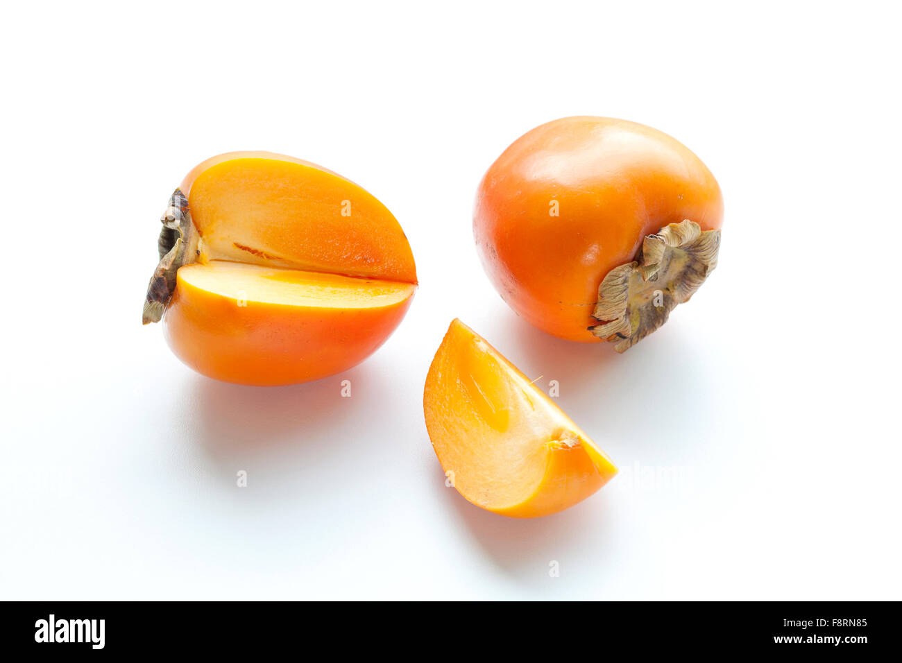 Ripe persimmon with cut isolated on white background. Clipping Path ...