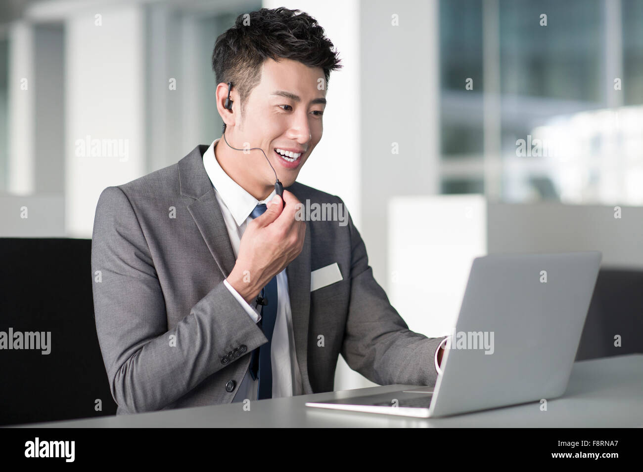 Young businessman using laptop Stock Photo - Alamy