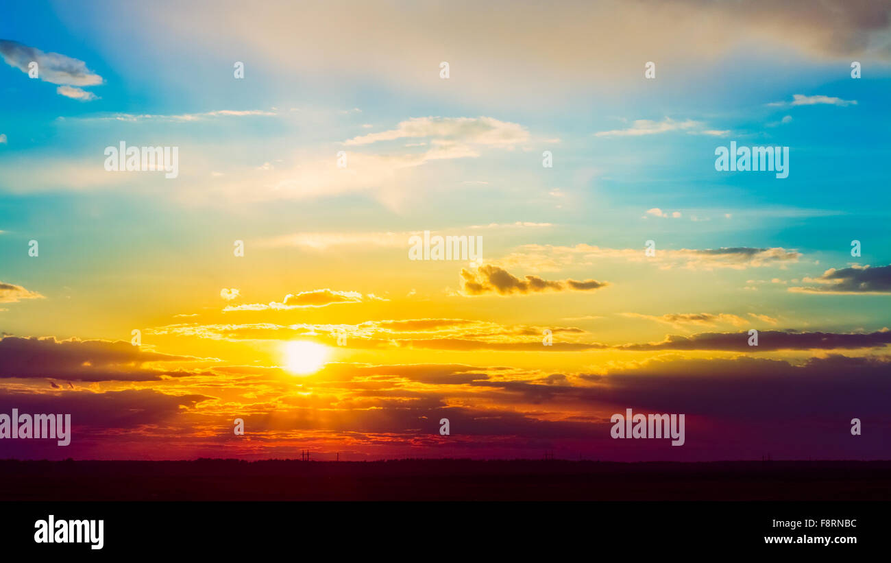 The sun shining over field. Bright Sun, Sunset, Sunrise. Colorful Blue ...