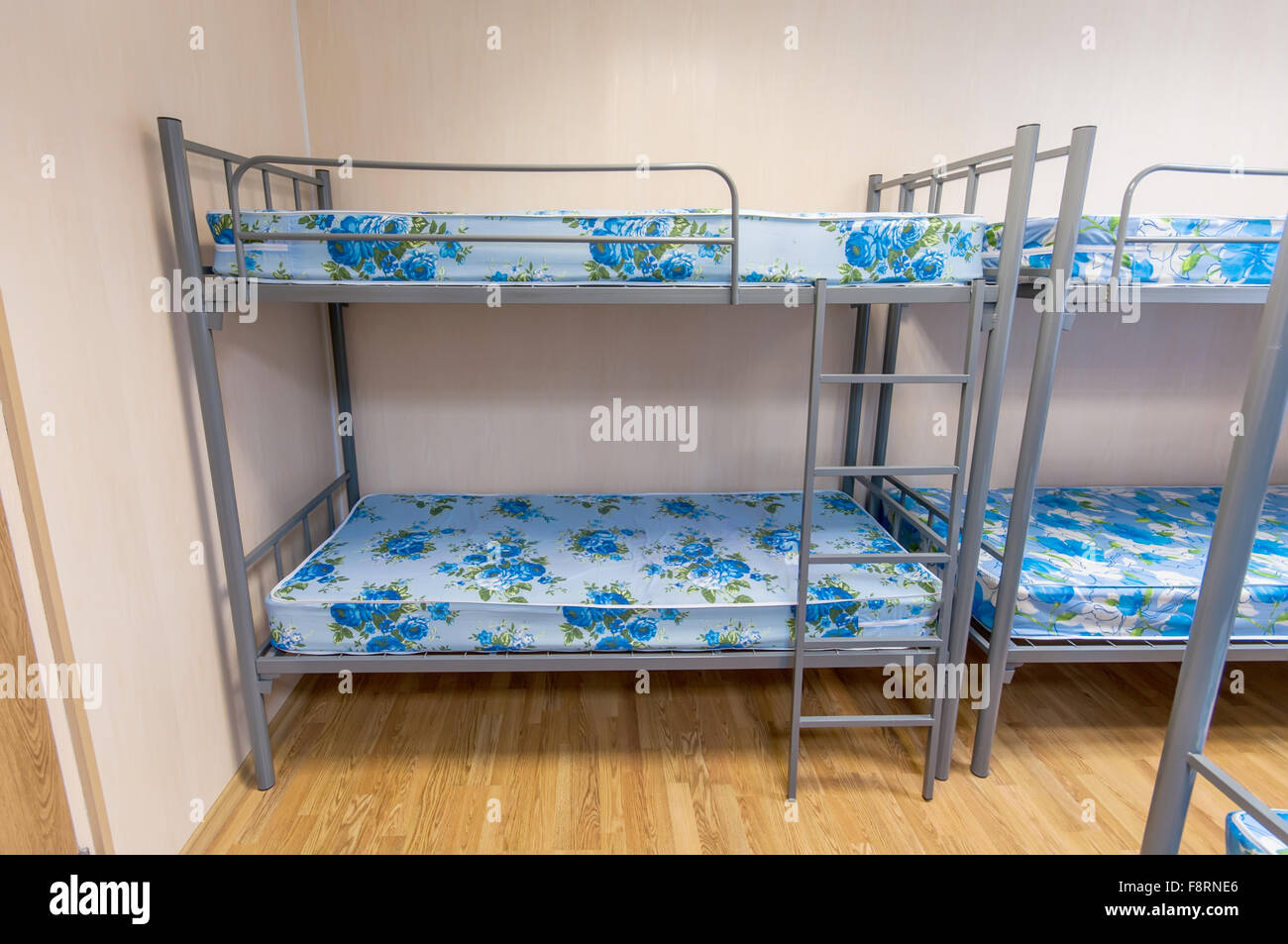 bunk metal beds in clean hostel room Stock Photo - Alamy