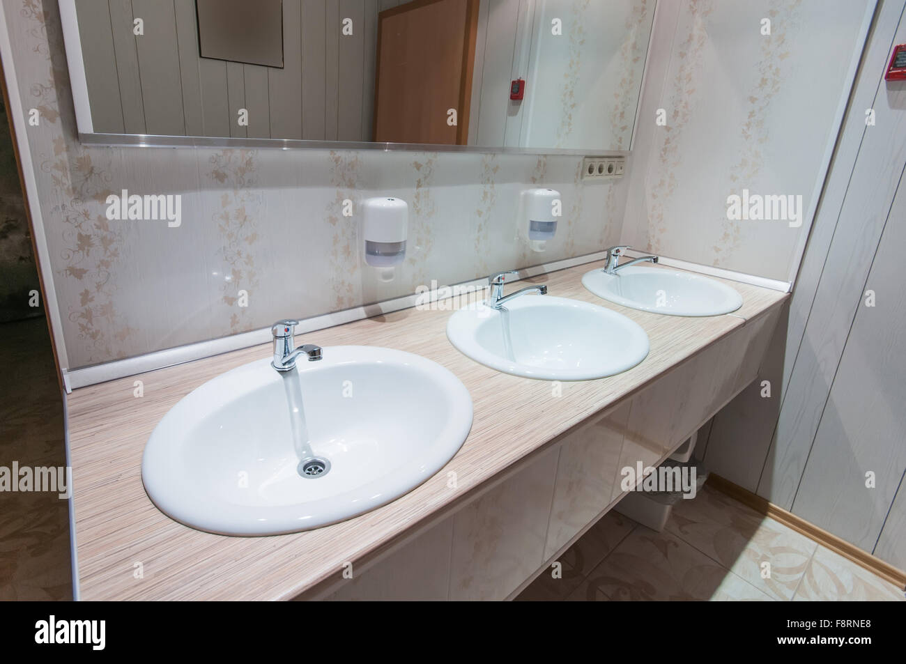 clean bathroom with sinks in the hostel Stock Photo - Alamy