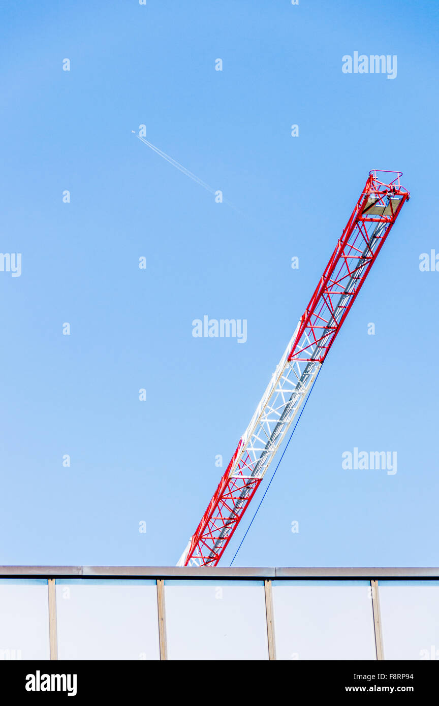 Crane with trail of plane Stock Photo - Alamy
