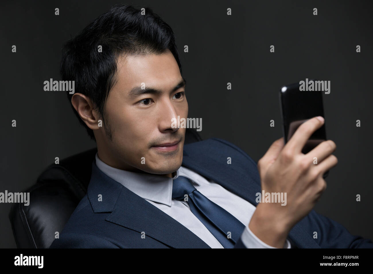 Confident businessman using smart phone Stock Photo - Alamy Confident businessman using smart phone Stock Photo - Alamy