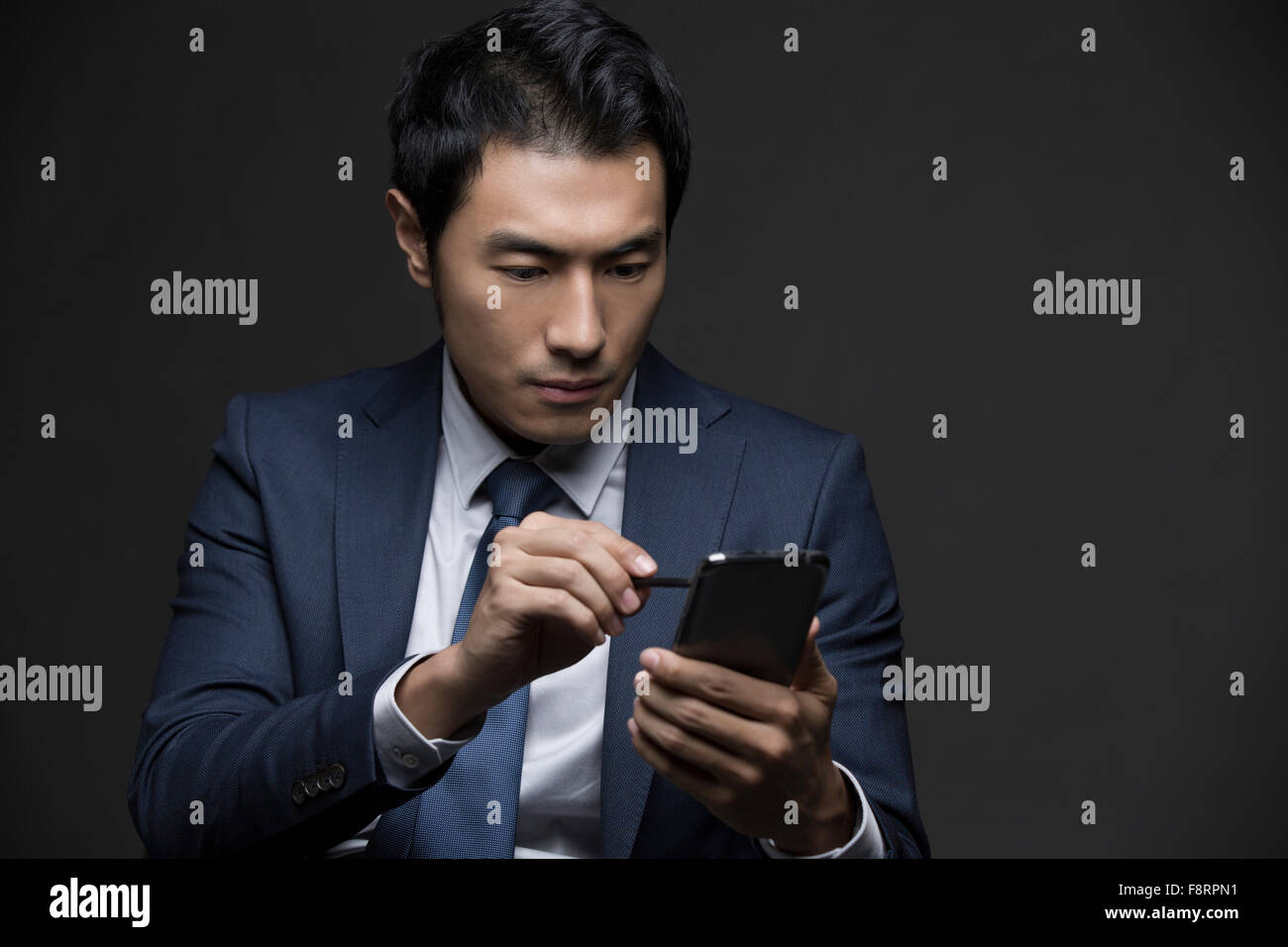 Young chinese businessman writing down hi-res stock photography and ...
