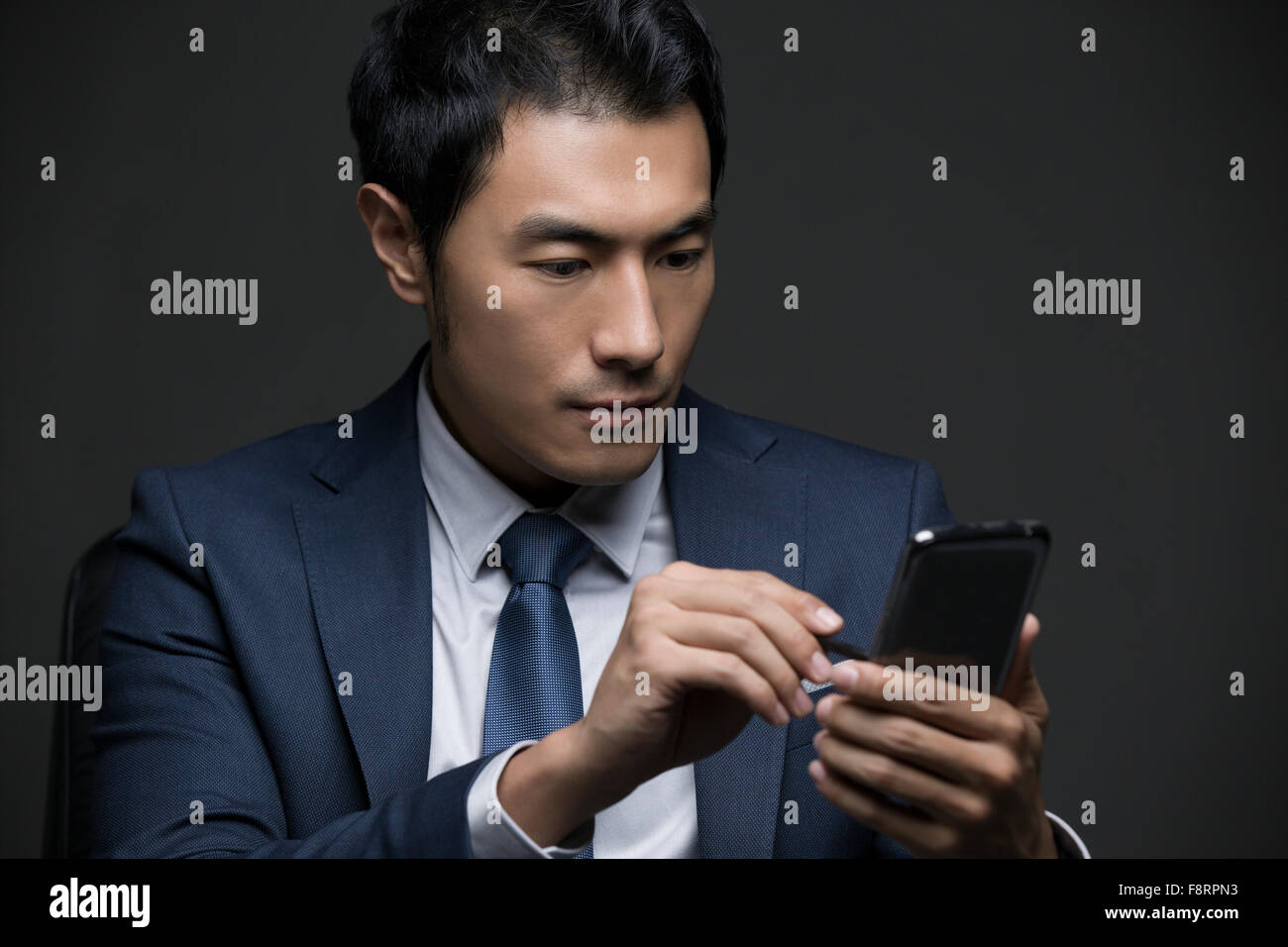 Confident businessman using smart phone Stock Photo - Alamy Confident businessman using smart phone Stock Photo - Alamy