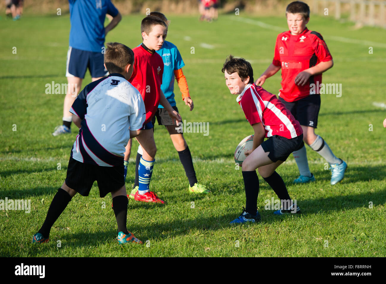 Young children taking part in rugby training coaching practice ...