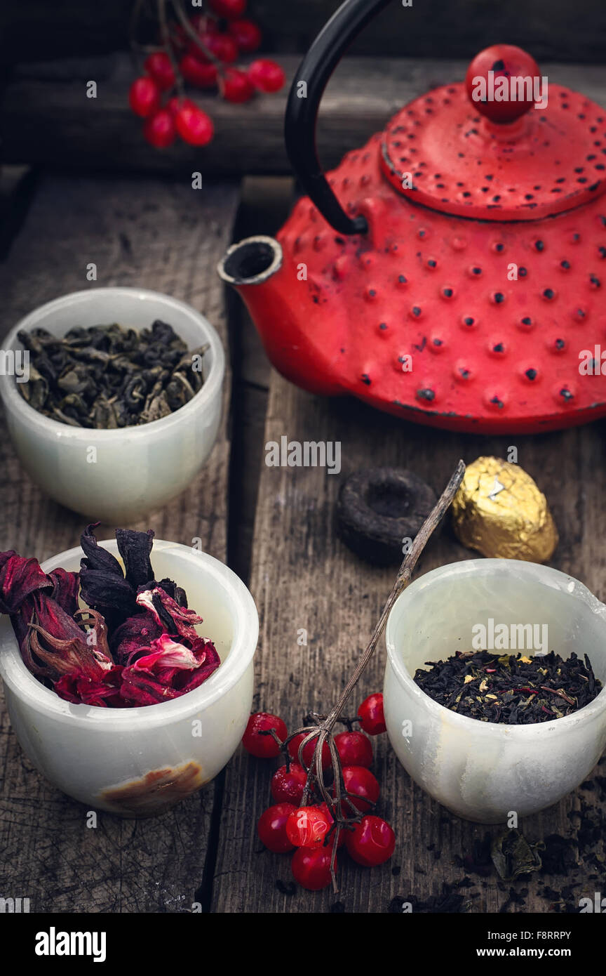 cup with tea brewing in the background spoons and kettle Stock Photo ...