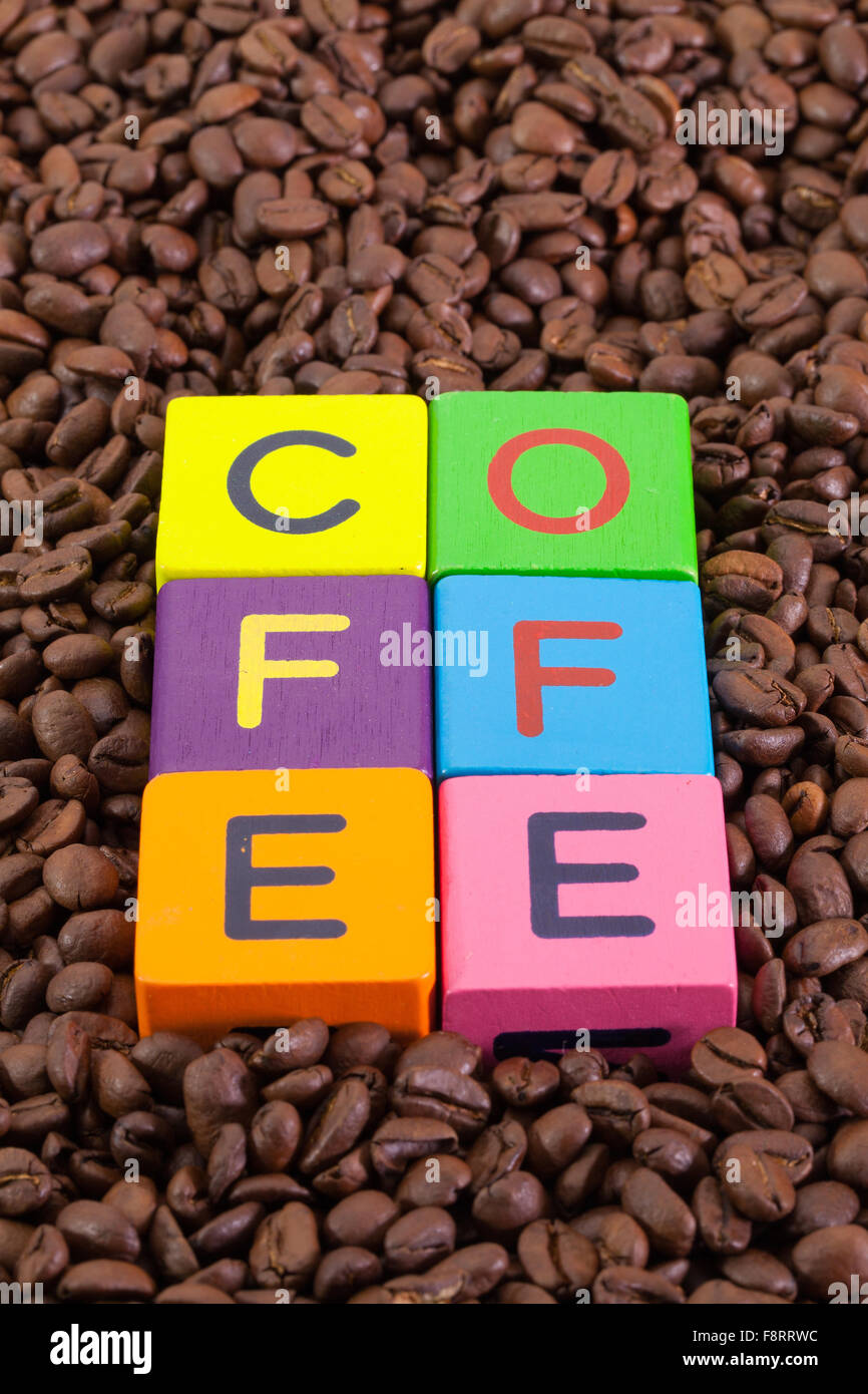 Colored children's cubes and coffee beans Stock Photo - Alamy